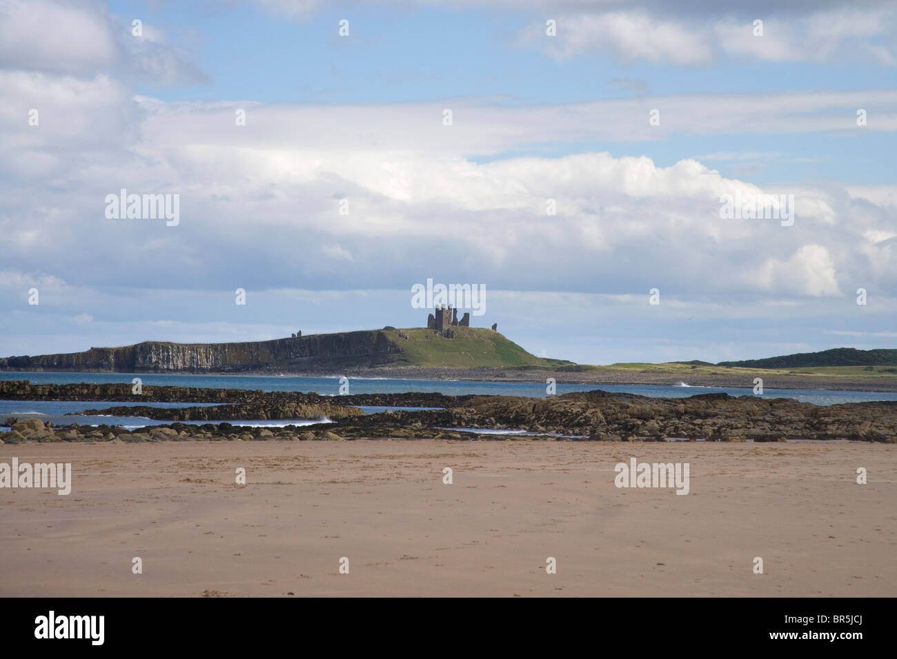 dunstanburgh castle viewed from low newton beach Stock Photo - Alamy