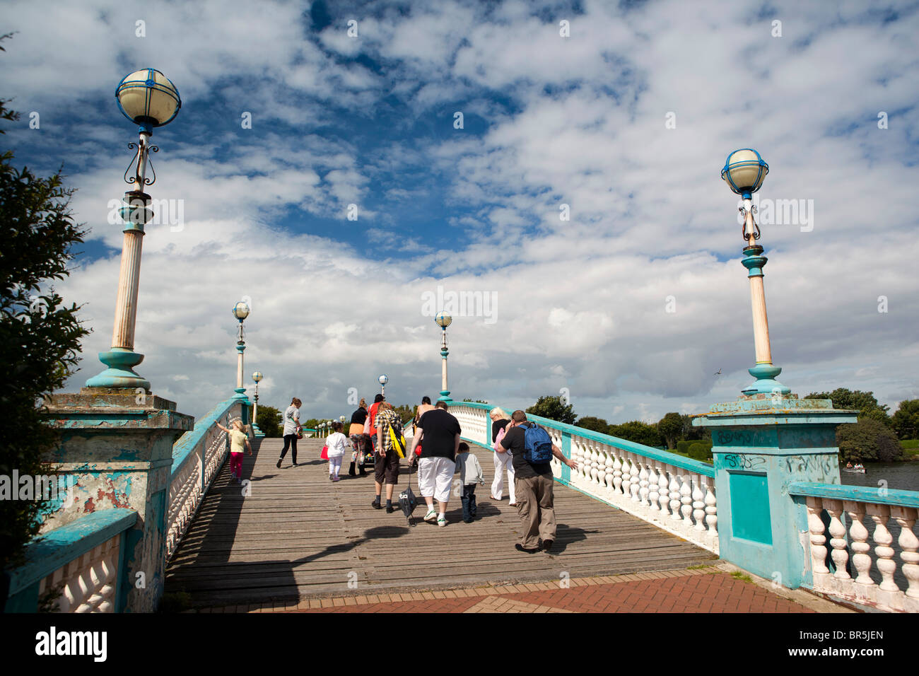 UK, England, Merseyside, Southport, visitors walking on bridge over ...
