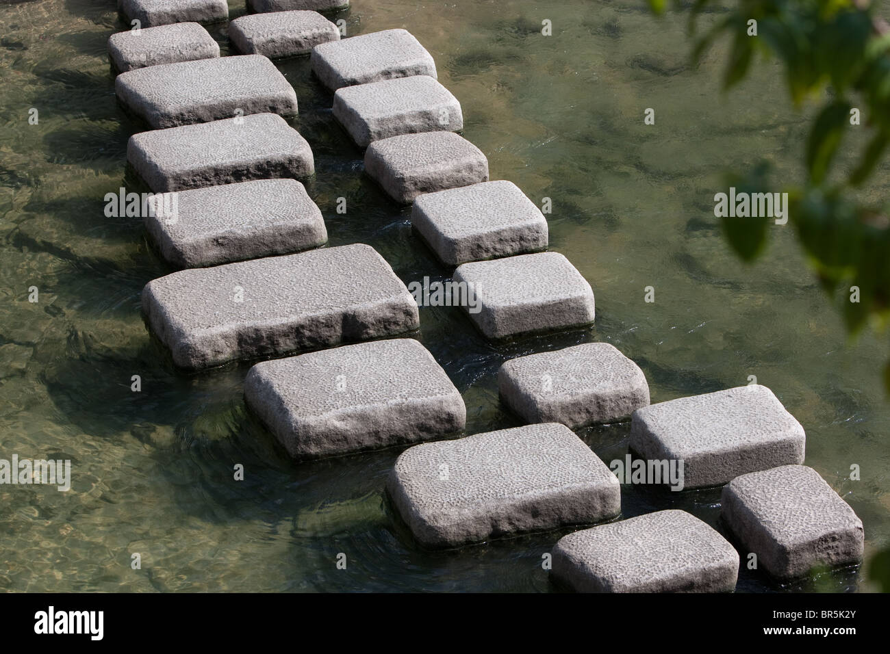 Waterside and stepping stone bridge across the Cheonggyecheon stream ...