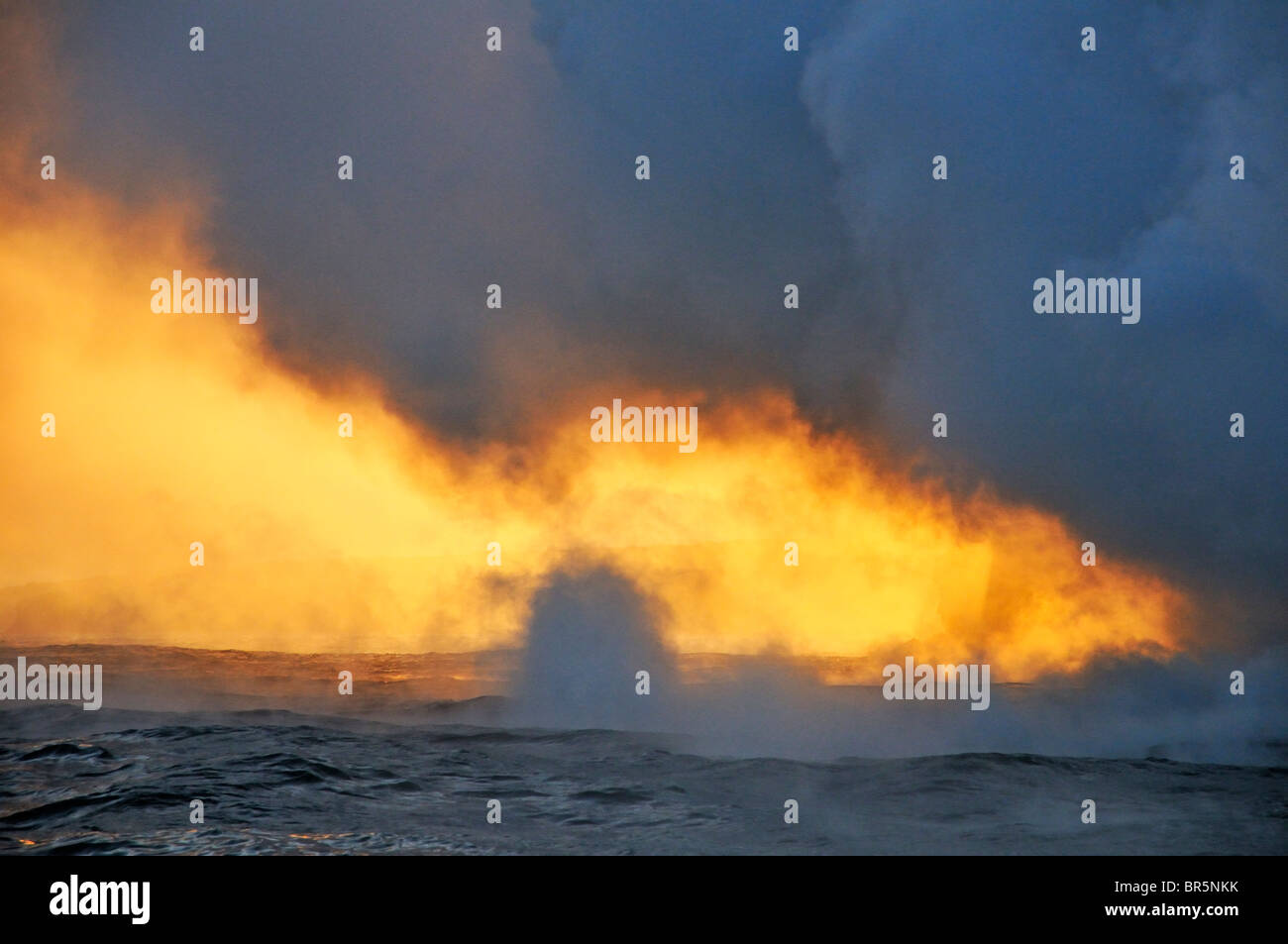 Steam rising off lava flowing into ocean at sunset, Kilauea Volcano ...