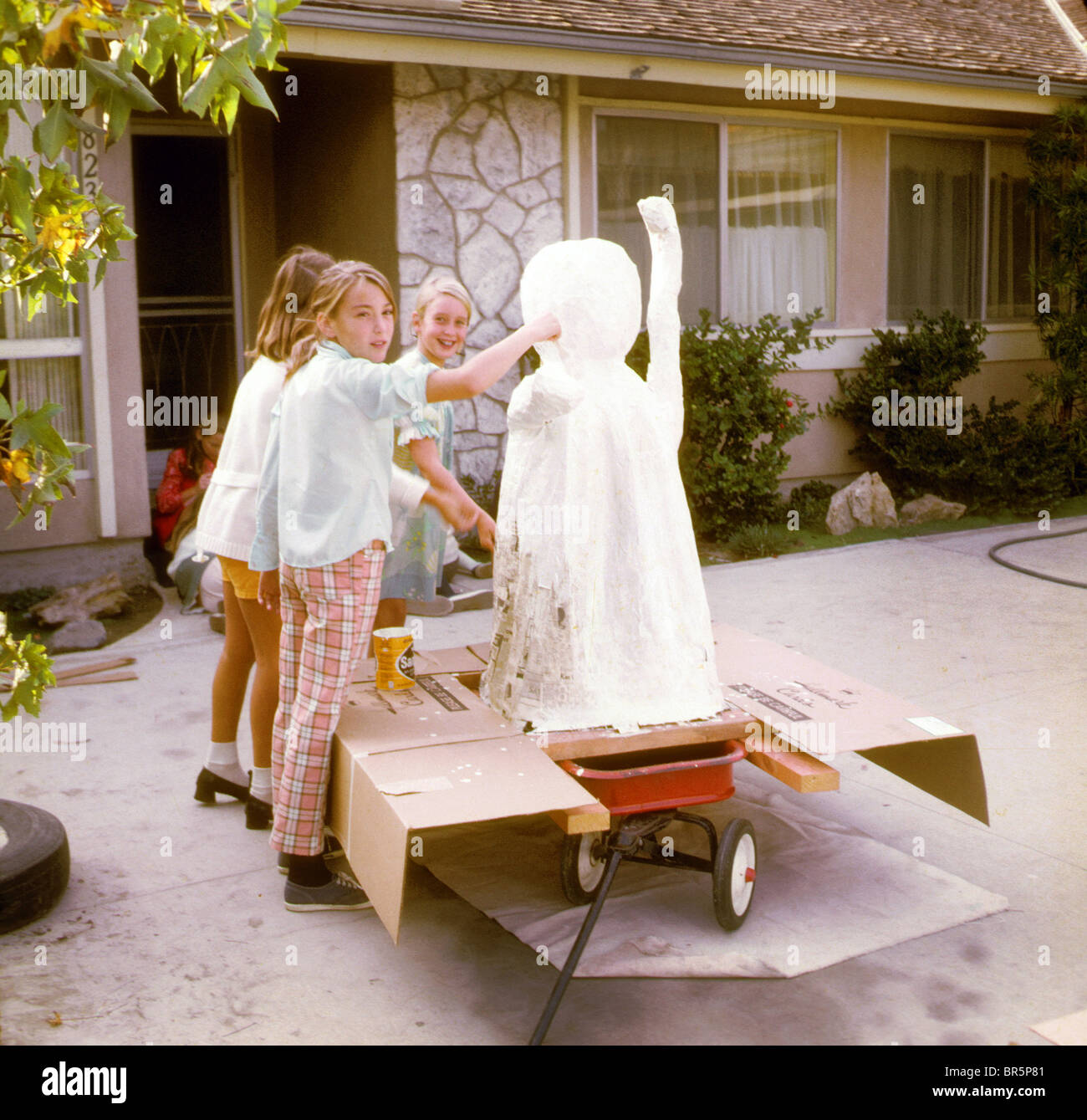 Young Girl Scouts work on papier mache figure for school parade float ...
