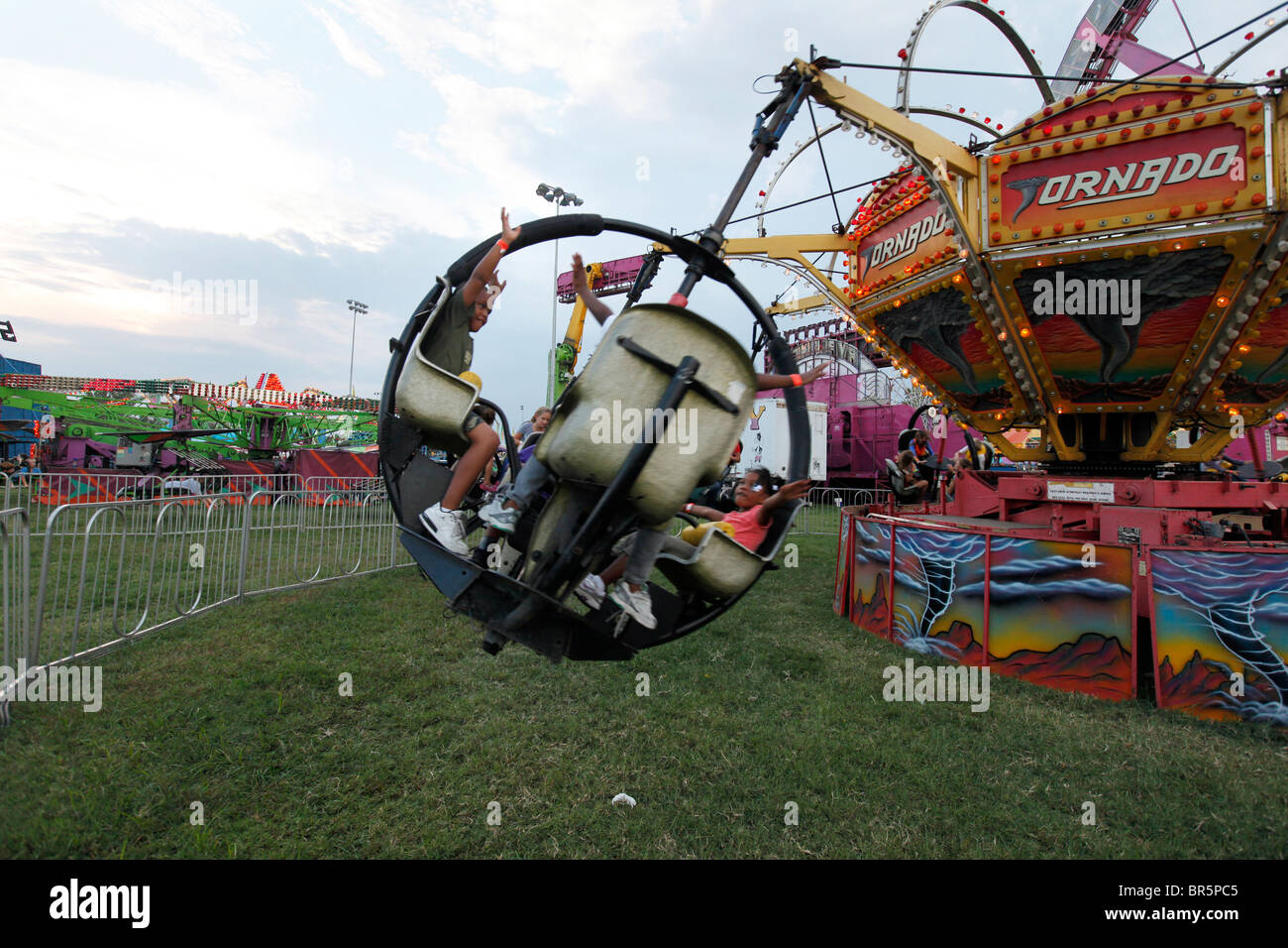 Spinning carnival ride "Tornado" at dusk in Cape Girardeau, Missouri ...