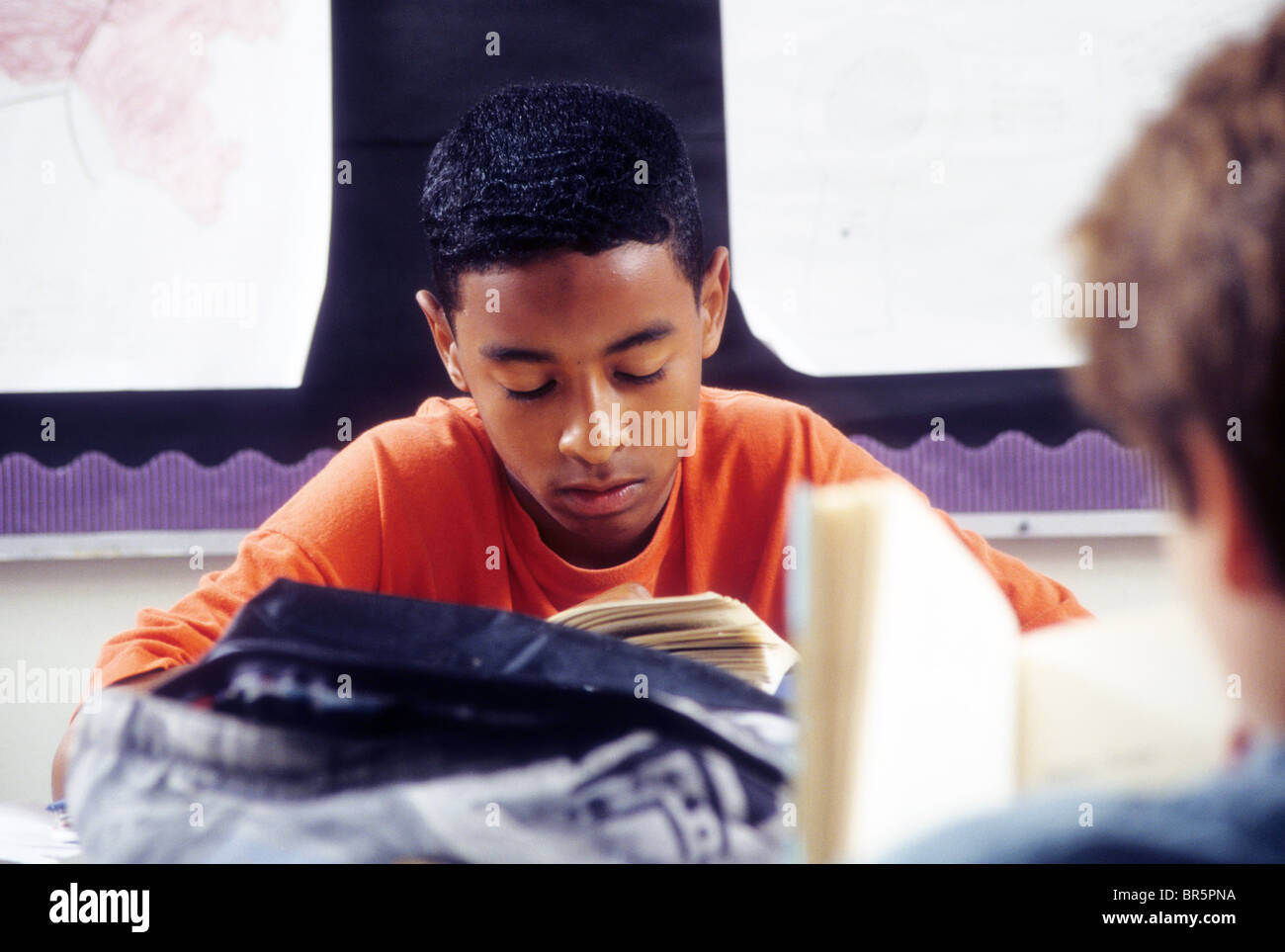 Black teen read table desk school class work homework concentrate ...