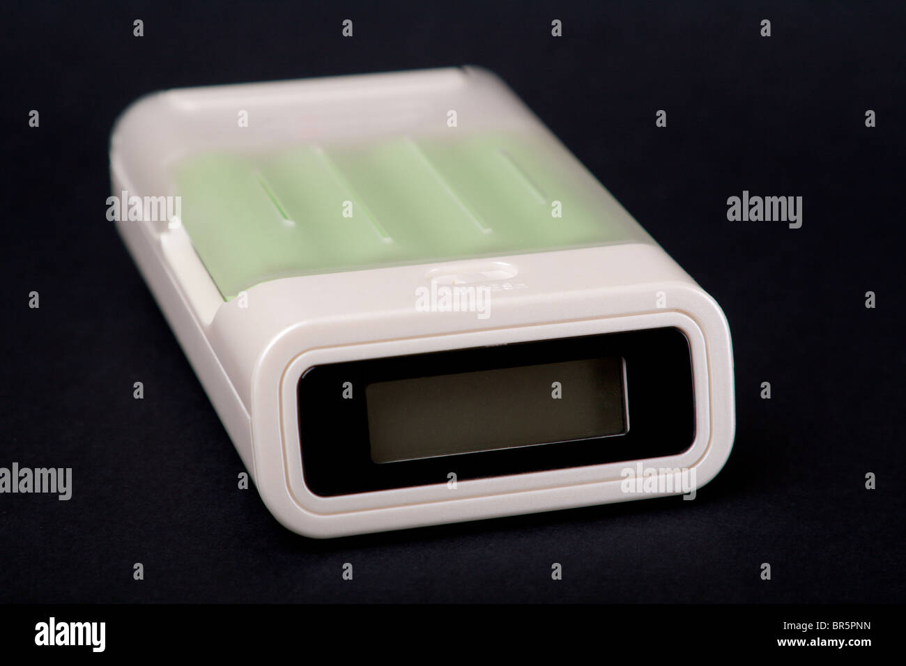 Battery charger on dark background Stock Photo - Alamy