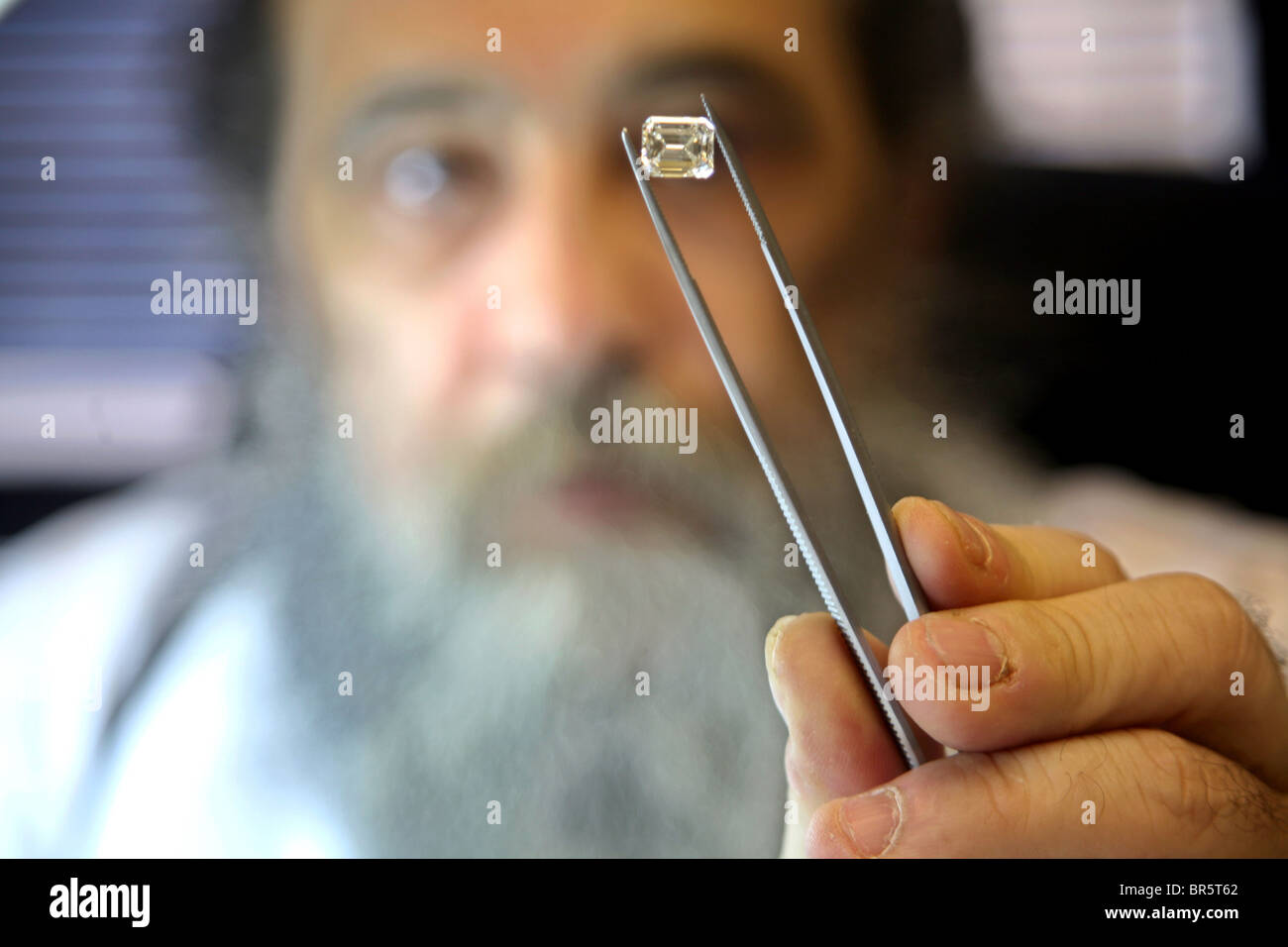 An Orthodox Jewish diamond dealer shows off the quality of one of his ...