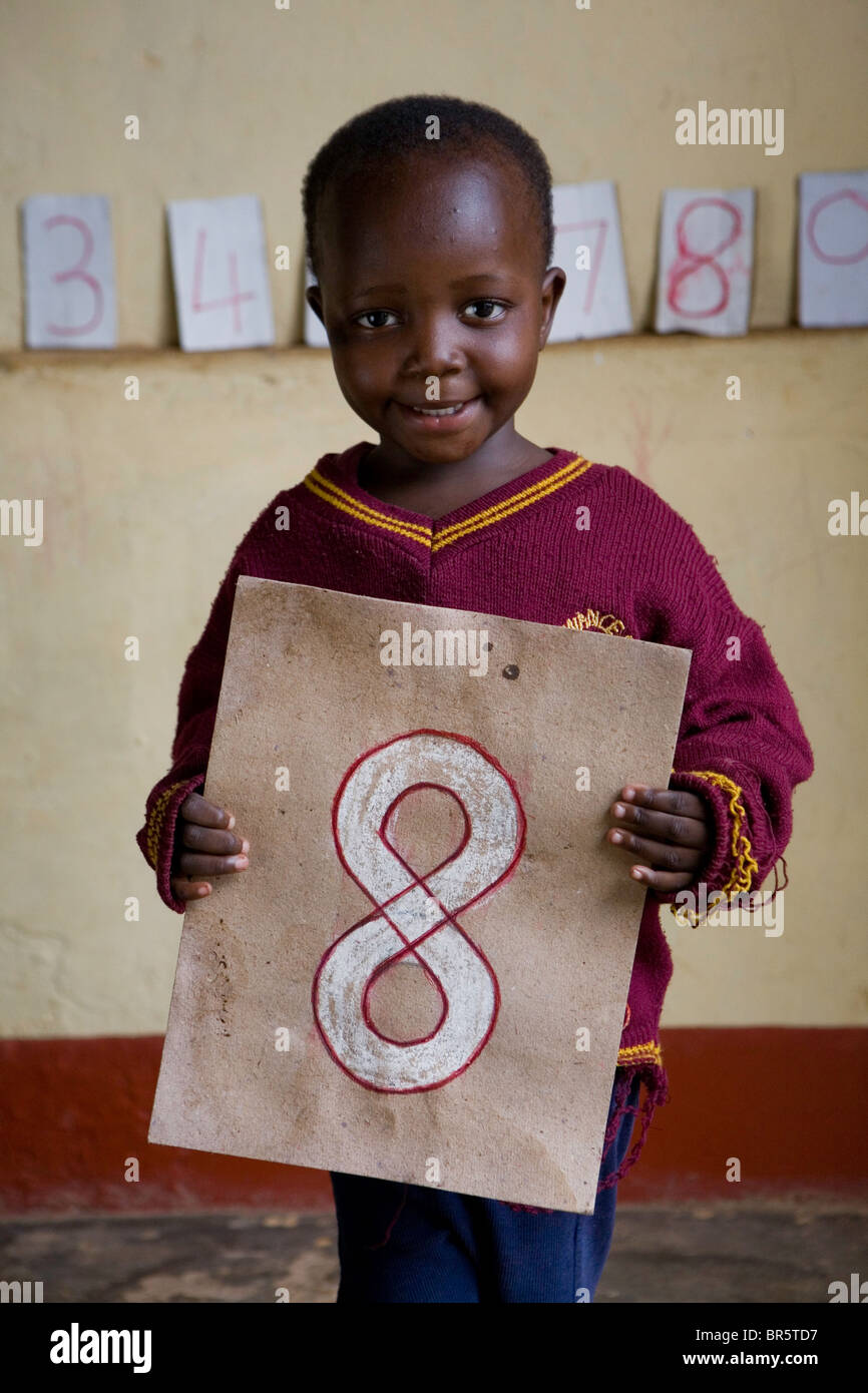 A young boy holds up a sign of his favourite number 8 during a class at ...