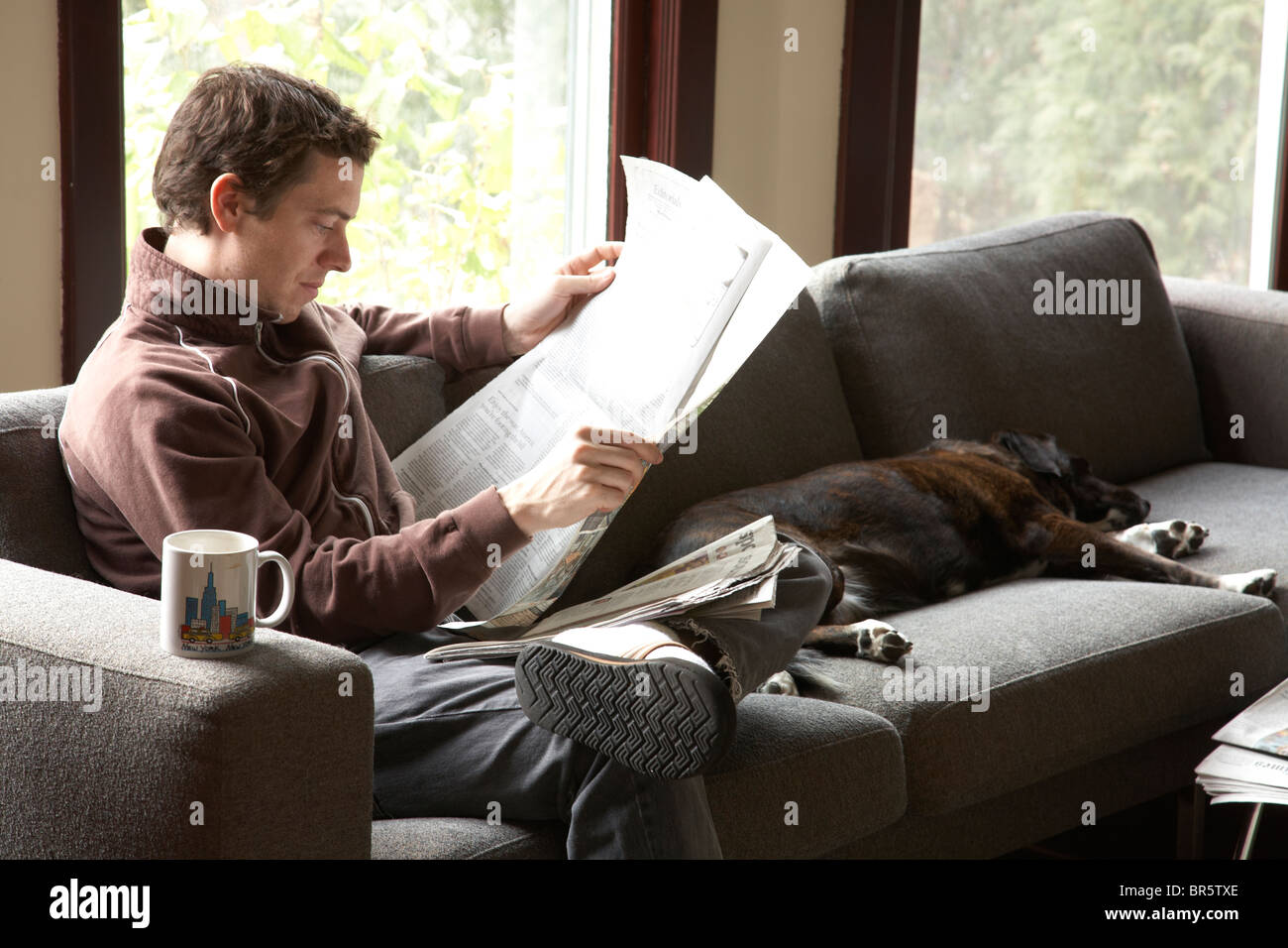 Man reading newspaper dog hi-res stock photography and images - Alamy