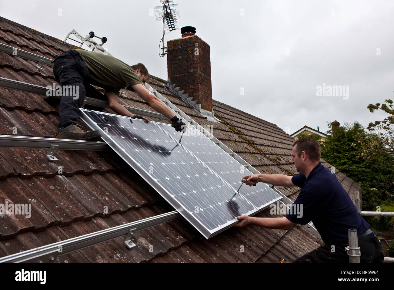 Solar PV Photo Voltaic panels being installed on roof of a home. PV ...