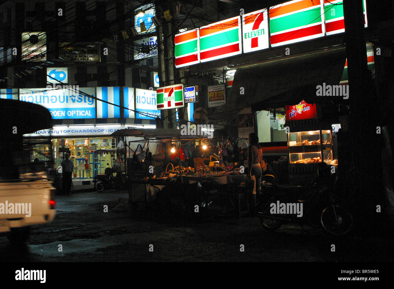 A Seven Eleven convenience store on a busy street corner of Bangkok ...