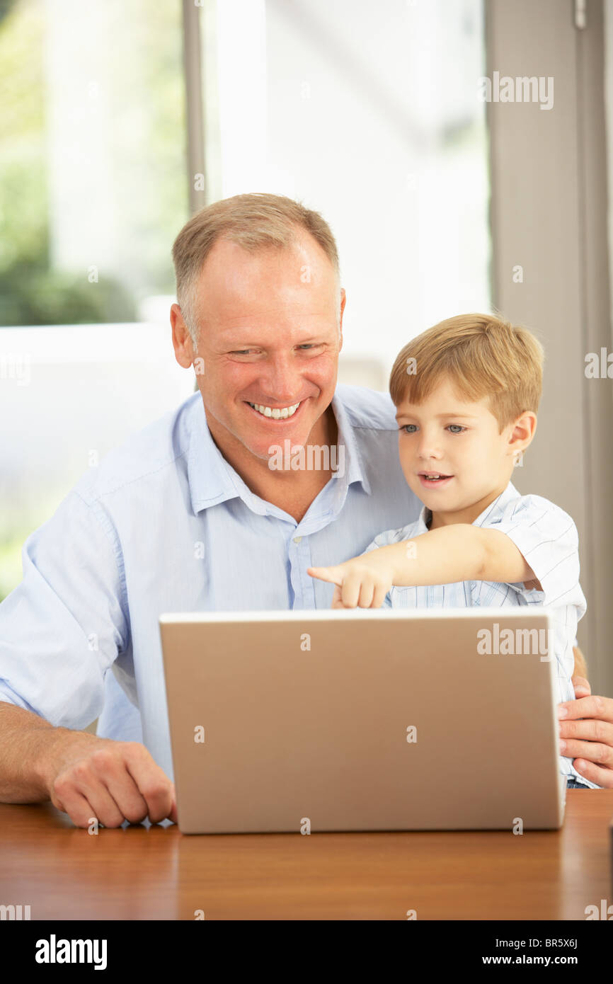 Father And Son Using Laptop At Home Stock Photo - Alamy