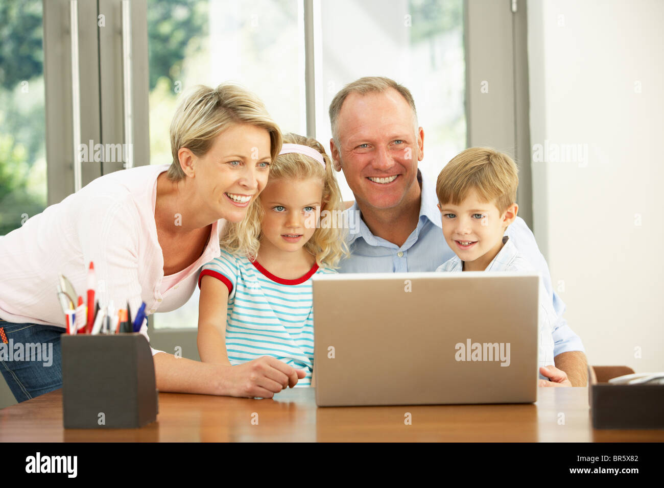 Happy family using technology hi-res stock photography and images - Alamy