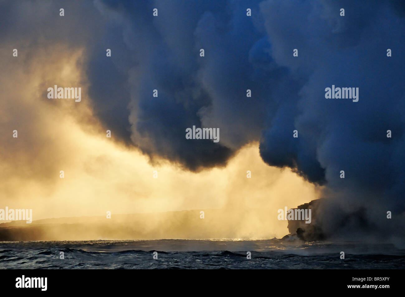 Steam rising off lava flowing into ocean at sunset, Kilauea Volcano ...