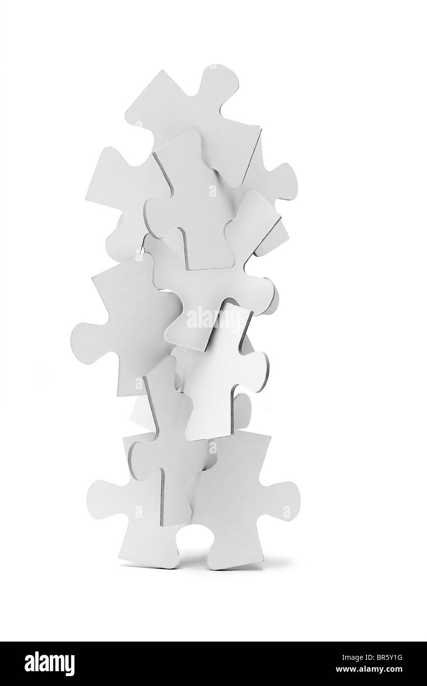 Interlocking pieces of jigsaw puzzles tower on white background Stock ...