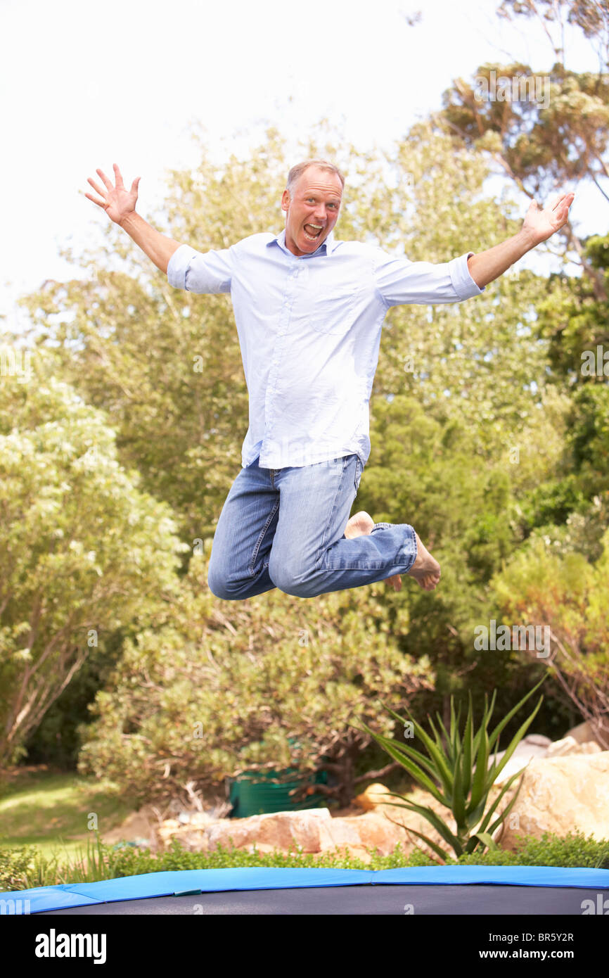 Middle Aged Man Jumping On Trampoline In Garden Stock Photo - Alamy Middle Aged Man Jumping On Trampoline In Garden Stock Photo - Alamy