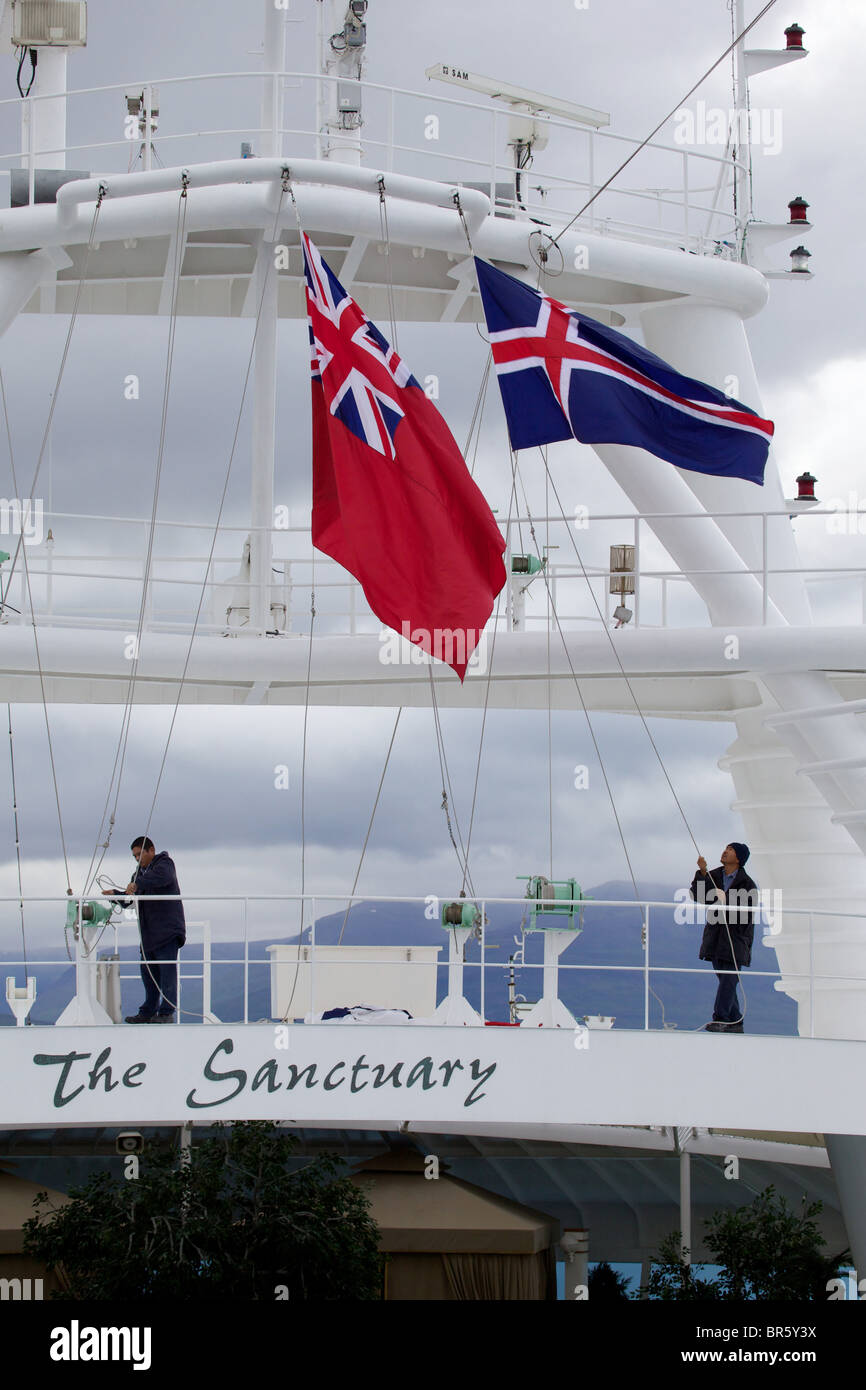 Ship workers hoisting the Icelandic flag alongside the Ensign flag as ...