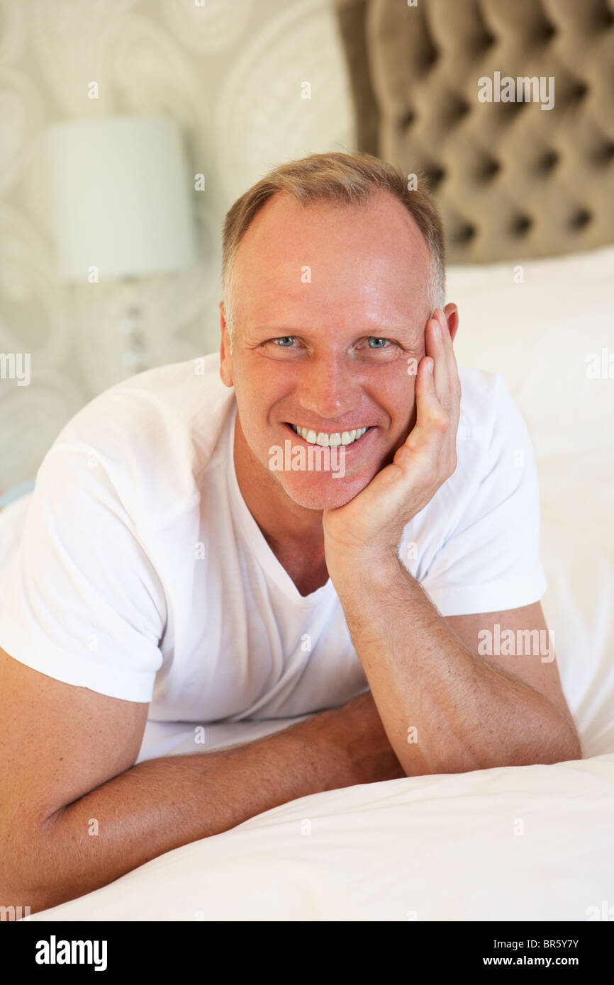 Man Relaxing In Bedroom Stock Photo - Alamy