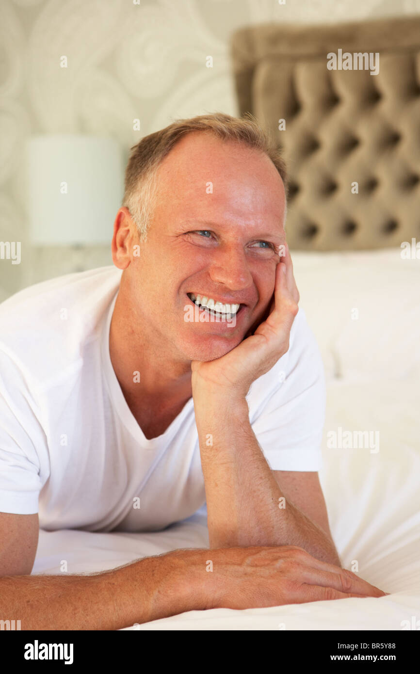 Man Relaxing In Bedroom Stock Photo - Alamy
