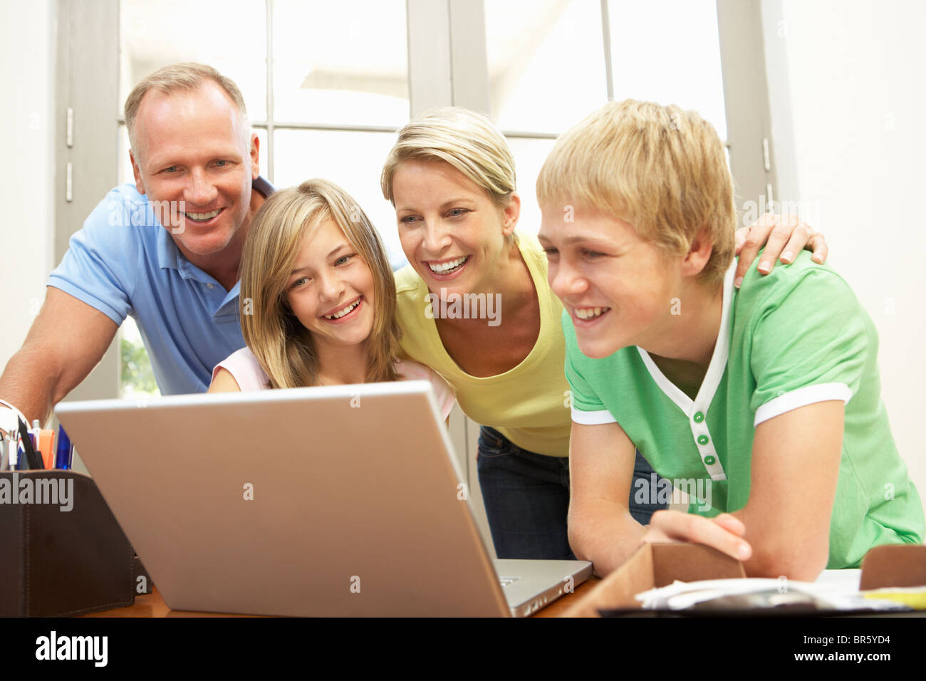 Family Using Laptop At Home Stock Photo - Alamy