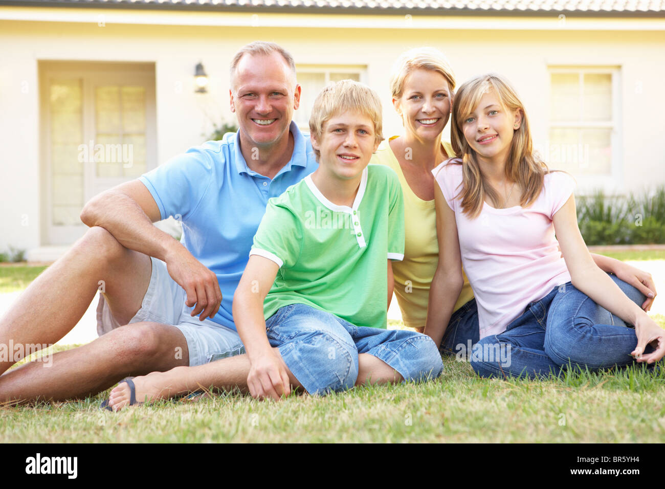 Family Sitting Outside Dream Home Stock Photo - Alamy