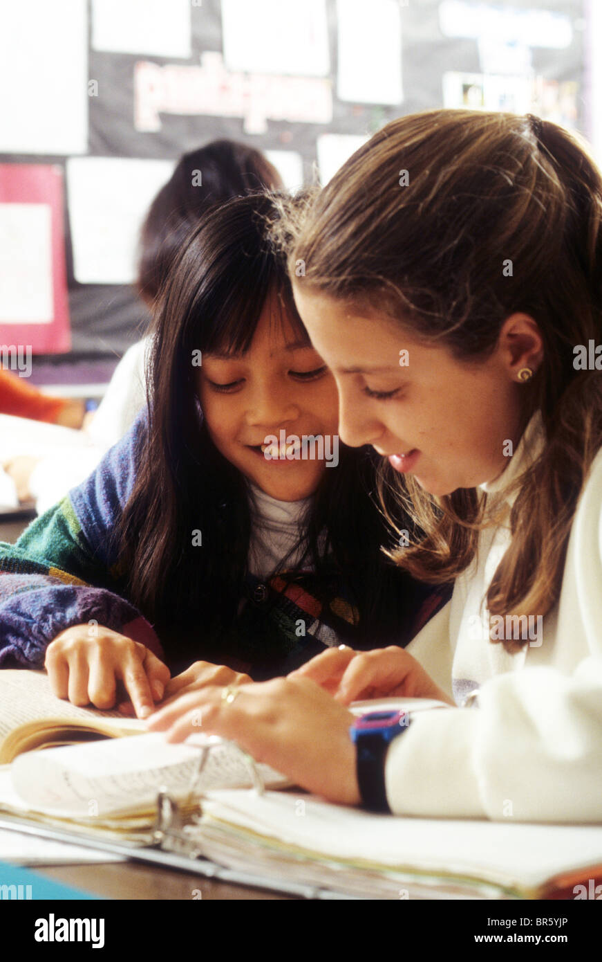 two girl friends student school study together share work project read ...