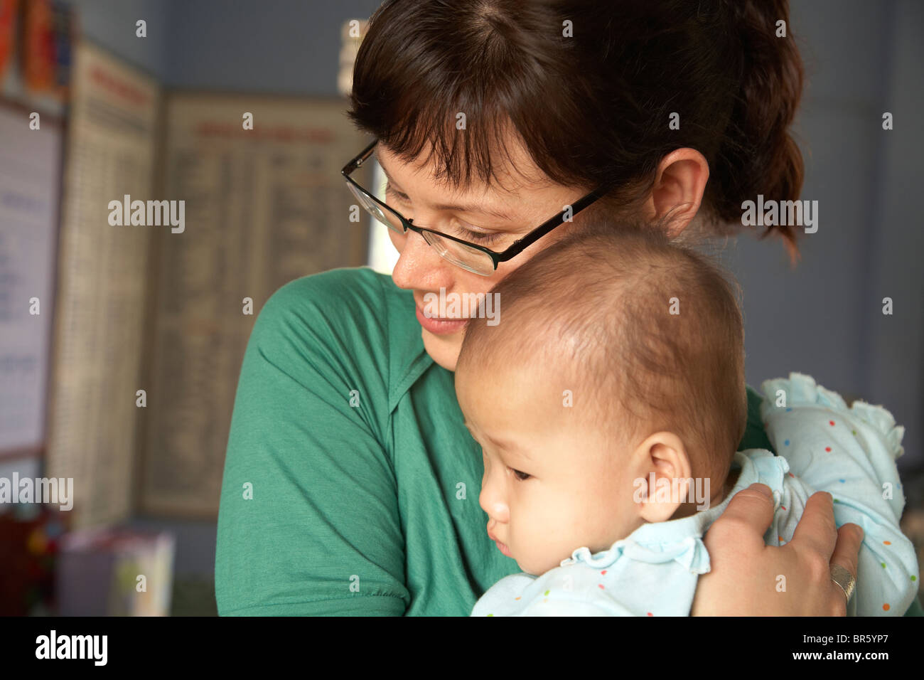 Mother hugging baby Stock Photo - Alamy