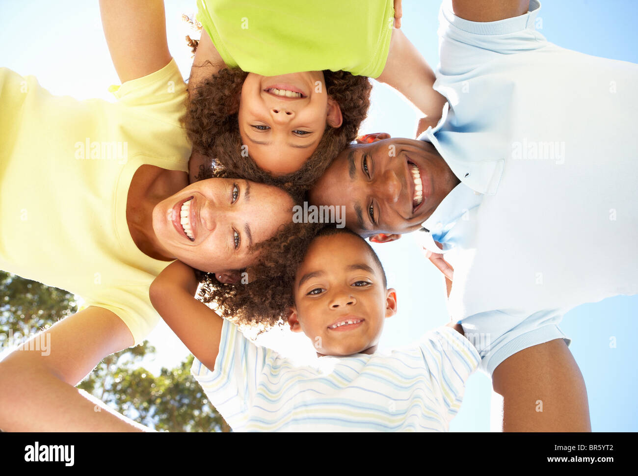 Portrait of Happy Family Looking Down Into Camera In Park Stock Photo ...