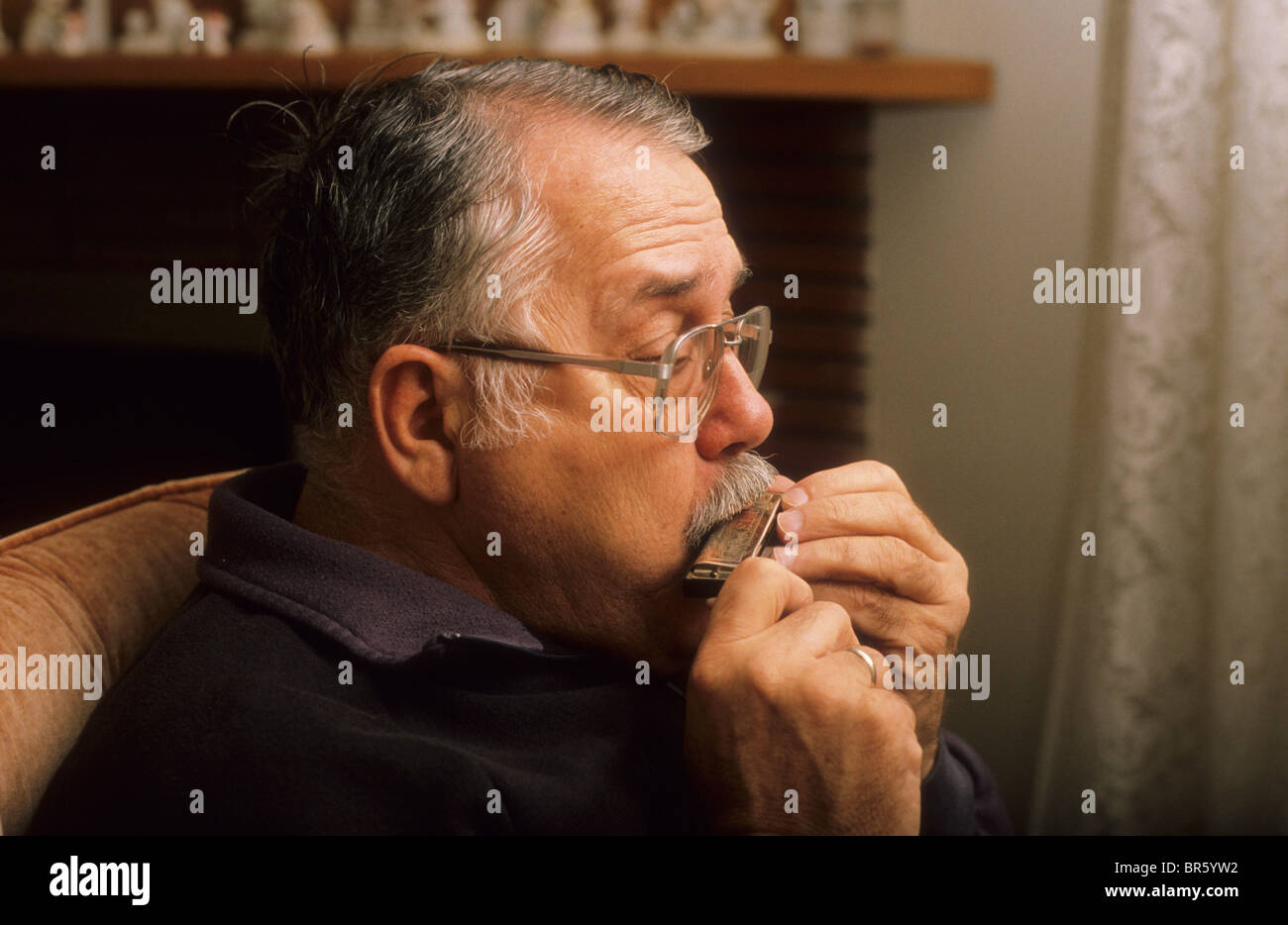 Senior male man play harmonica music instrument fun melody tune hobby ...