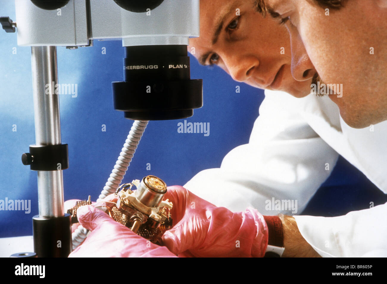 engineer company work on sensor for defense device camera clean room ...