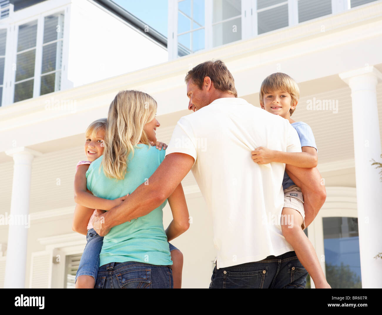 Young Family Standing Outside Dream Home Stock Photo - Alamy