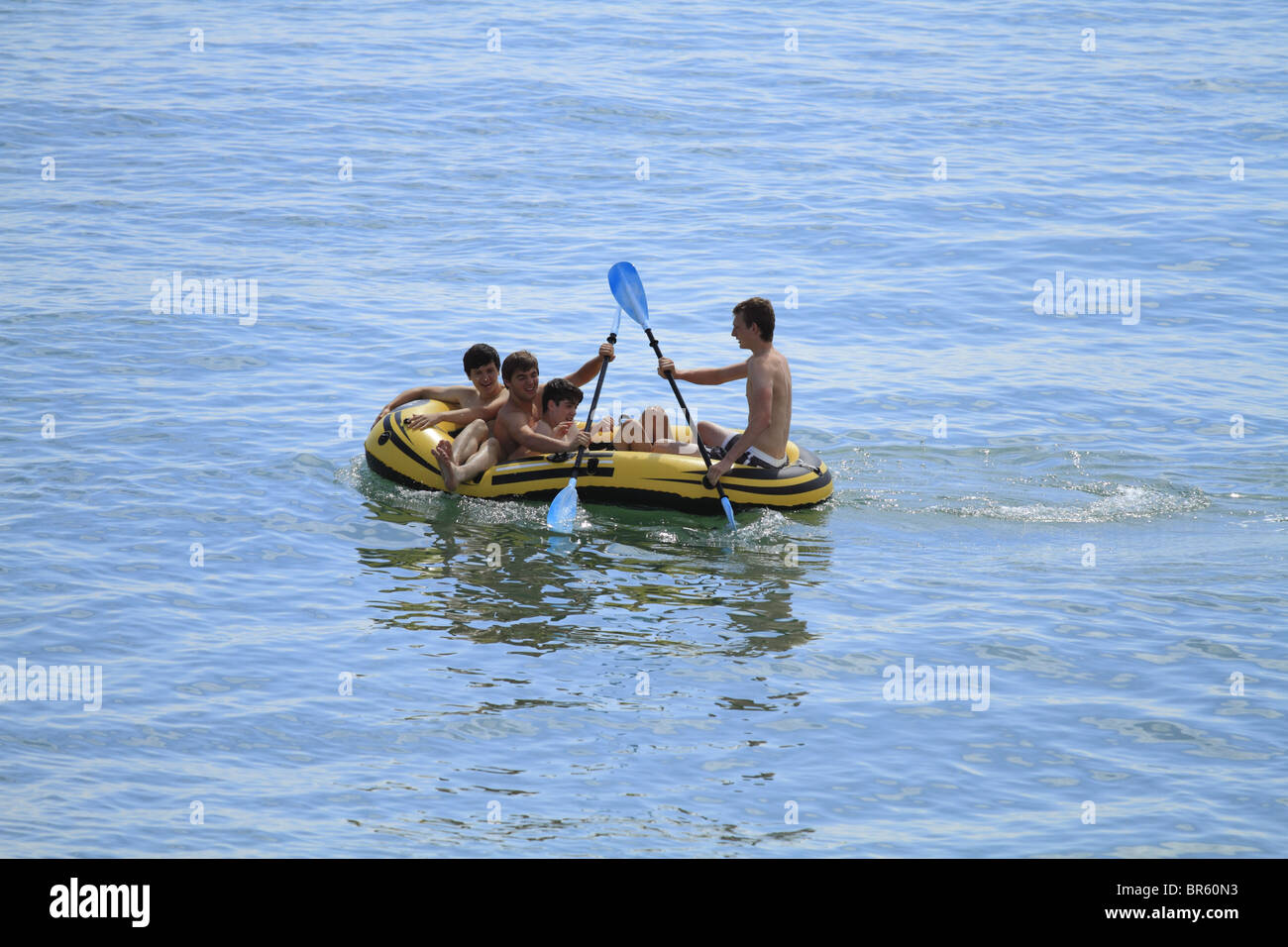 Four young boys play in a dingy at Eastbourne, East Sussex, England ...