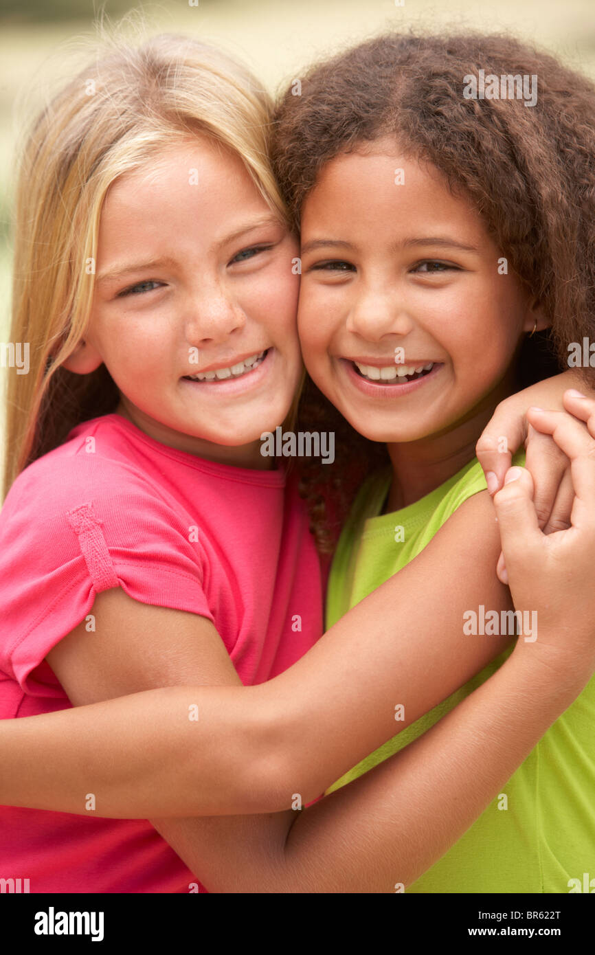 Two Girls In Park Giving Each Other Hug Stock Photo - Alamy
