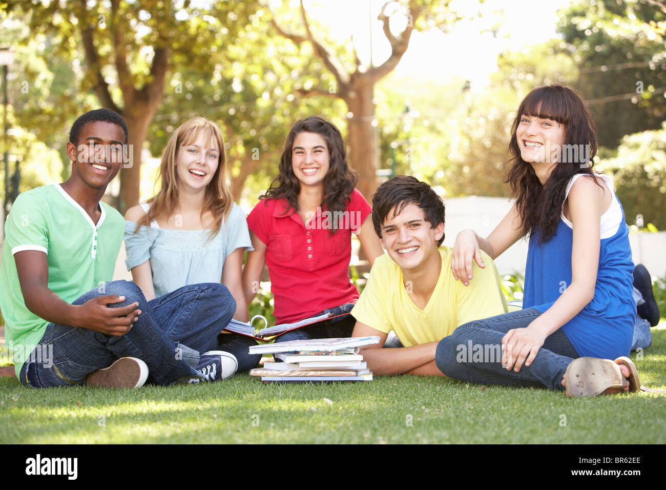 Group Of Teenage Students Chatting Together In Park Stock Photo - Alamy