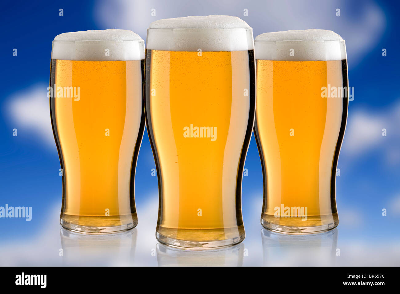 3 beers on a sky background Stock Photo - Alamy