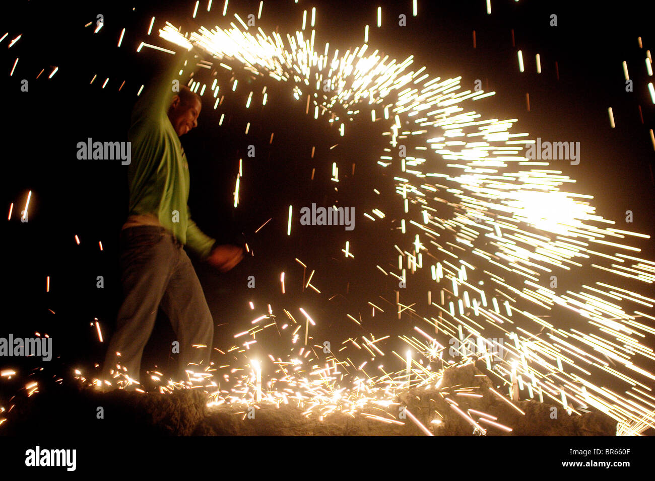A young man celebrates christmastime and the New Year with fireworks ...