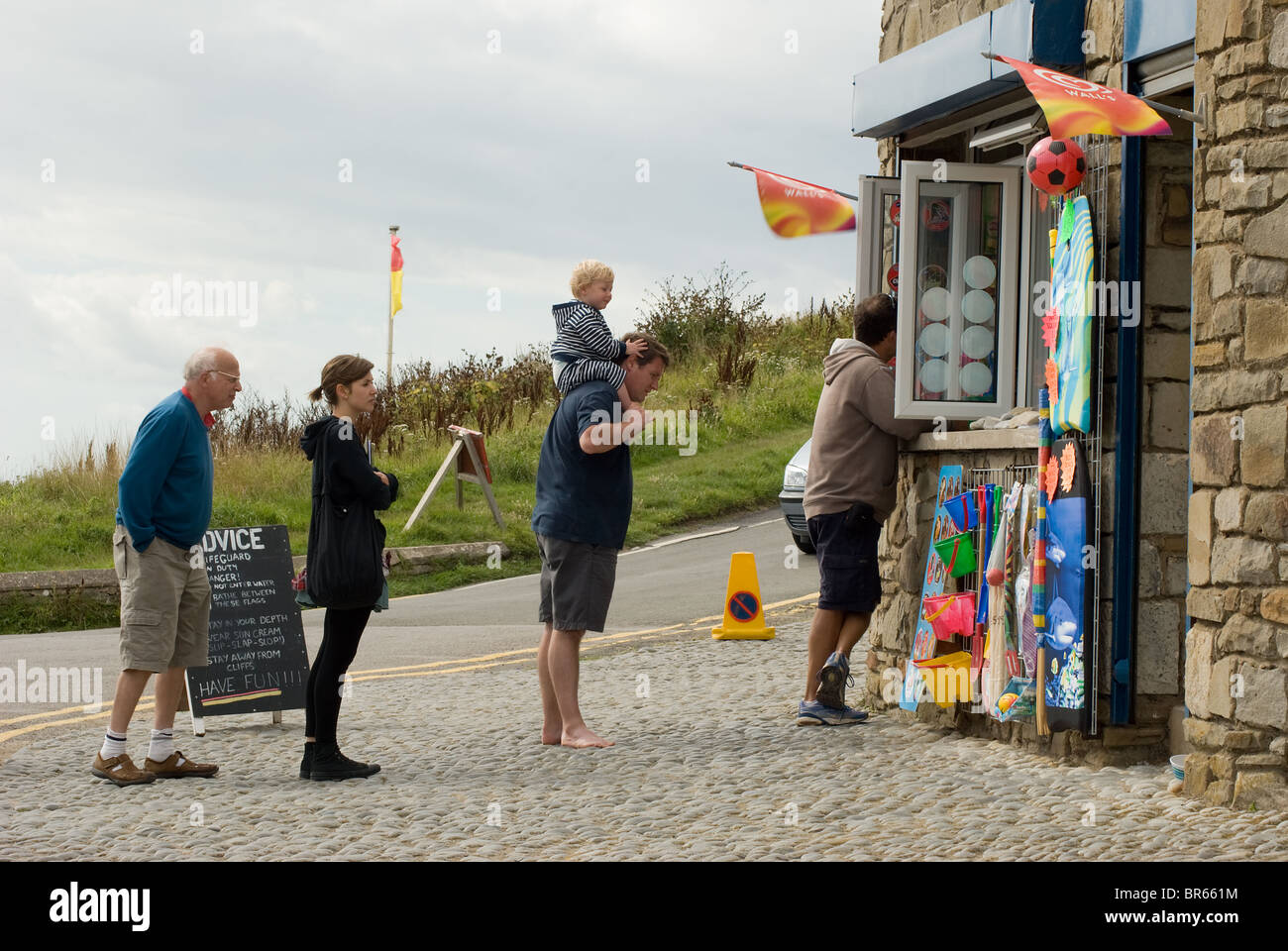 People queuing outside a shop in Southerndown, South Wales Stock Photo ...