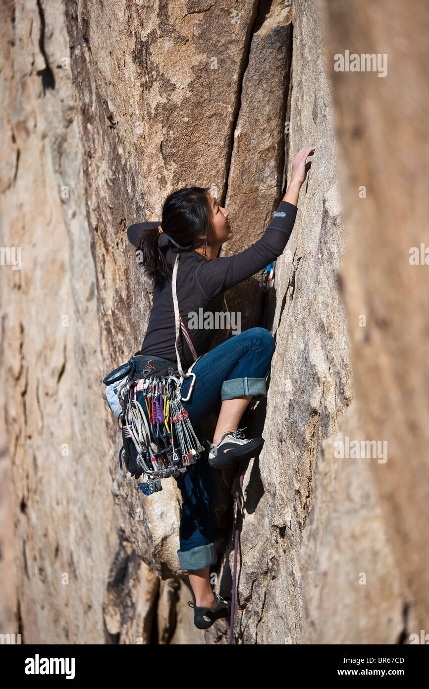 Female rock climber is focused on her next move as she battles her way ...
