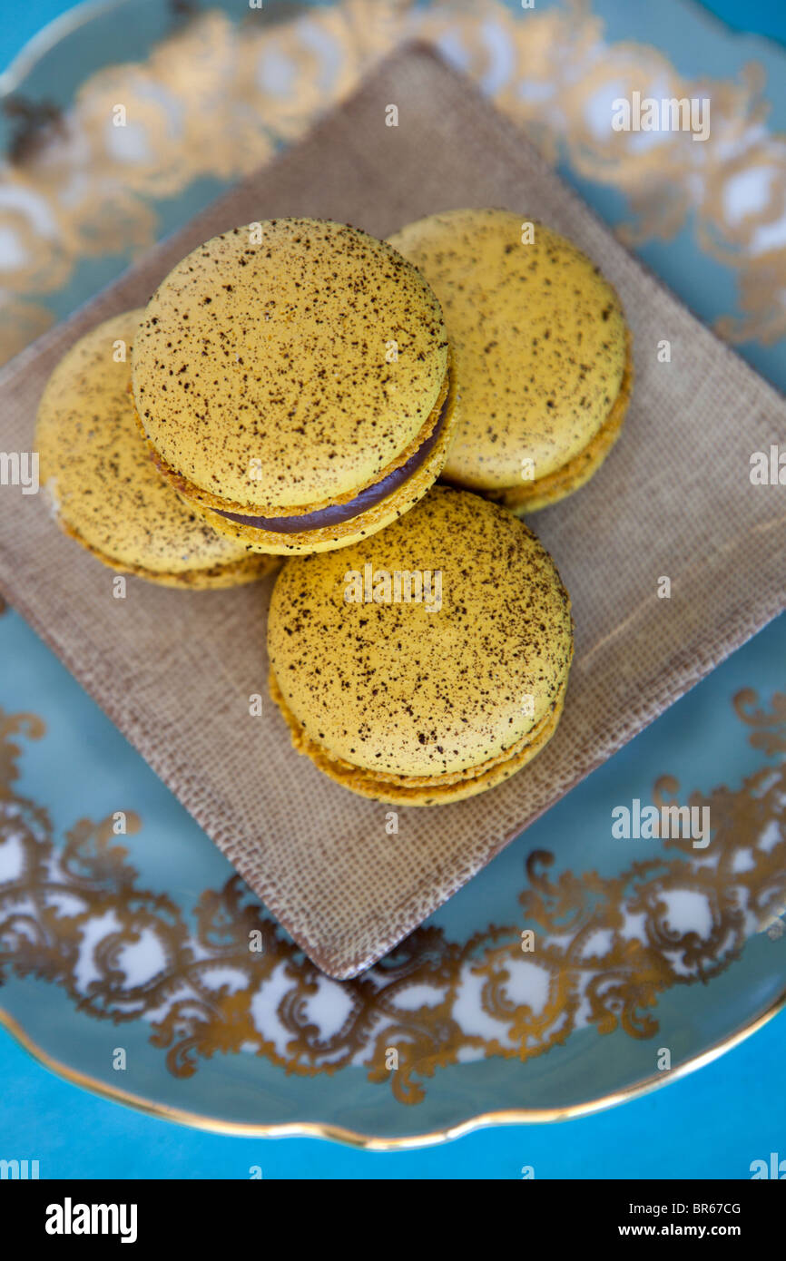 four yellow coffee flavored macaroon cookies Stock Photo - Alamy