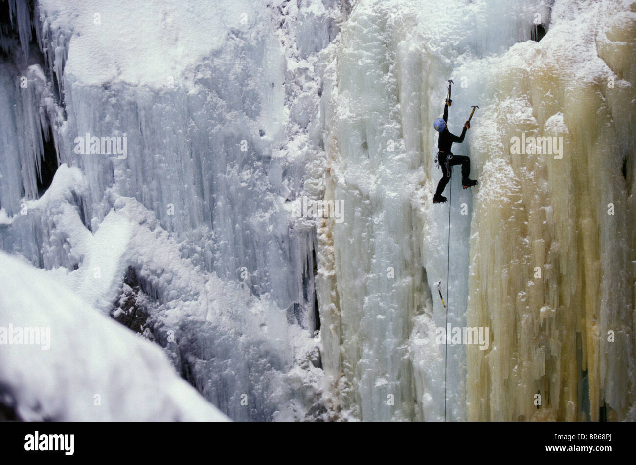A man ice climbing on a frozen waterfall Stock Photo - Alamy