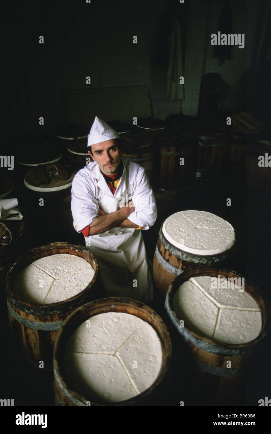 A cheese maker and barrels of aged feta cheese Stock Photo - Alamy