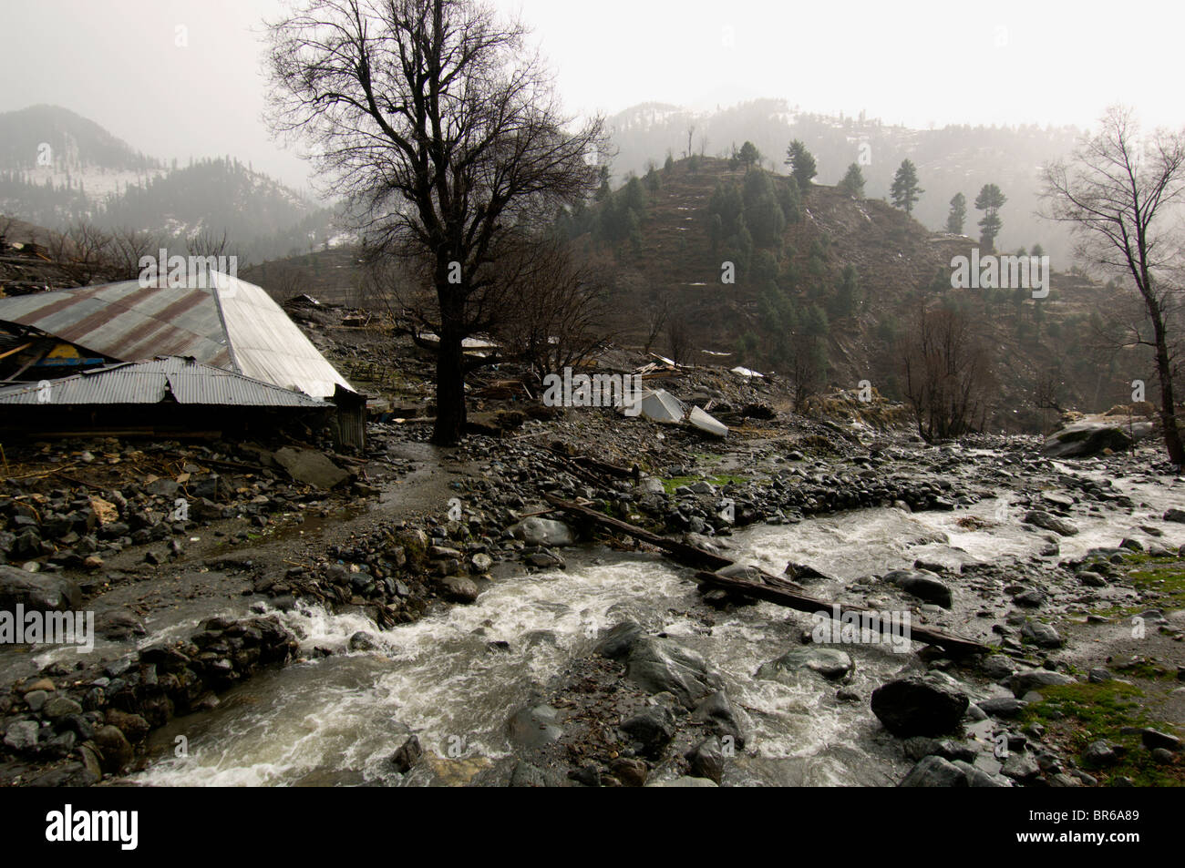 Collapsed buildings are soaked by rain in the mountain village of ...
