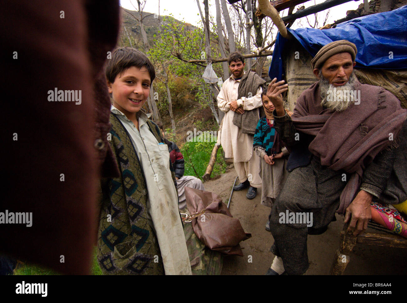 A Pashtun family who have just arrived back to their ruined mountain ...