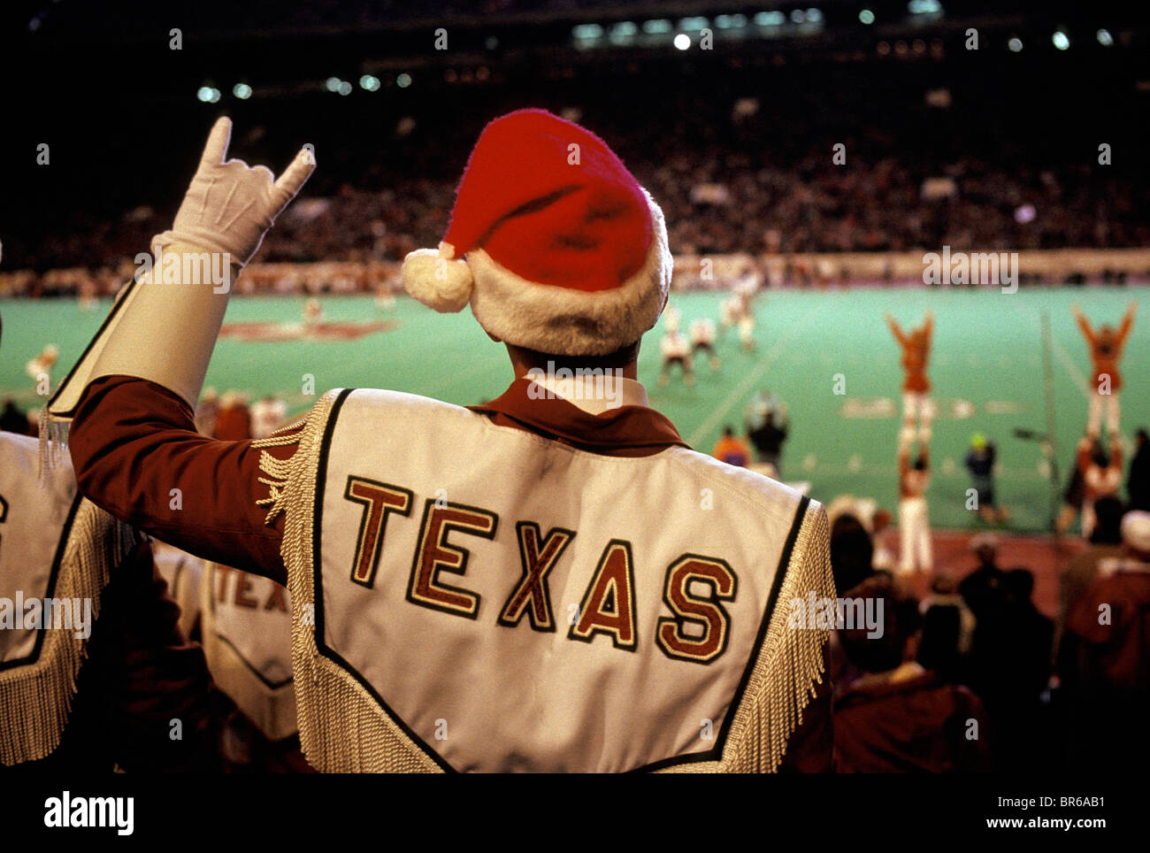 A Texas college football fan wears a santa hat and cheers on his team ...