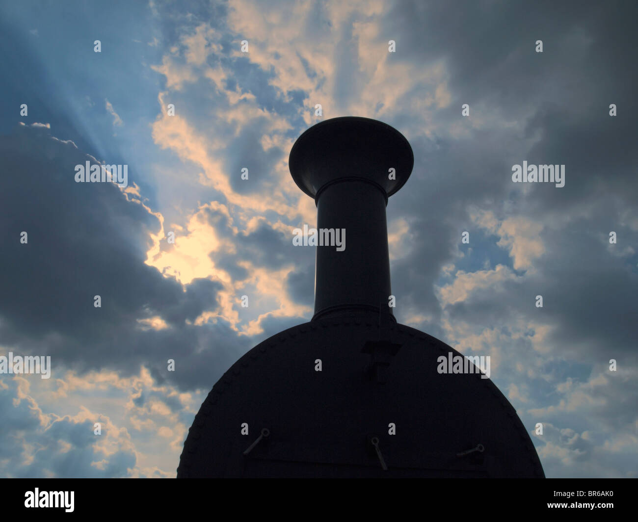 The chimney of vintage steam engine against sunset sky hi-res stock ...