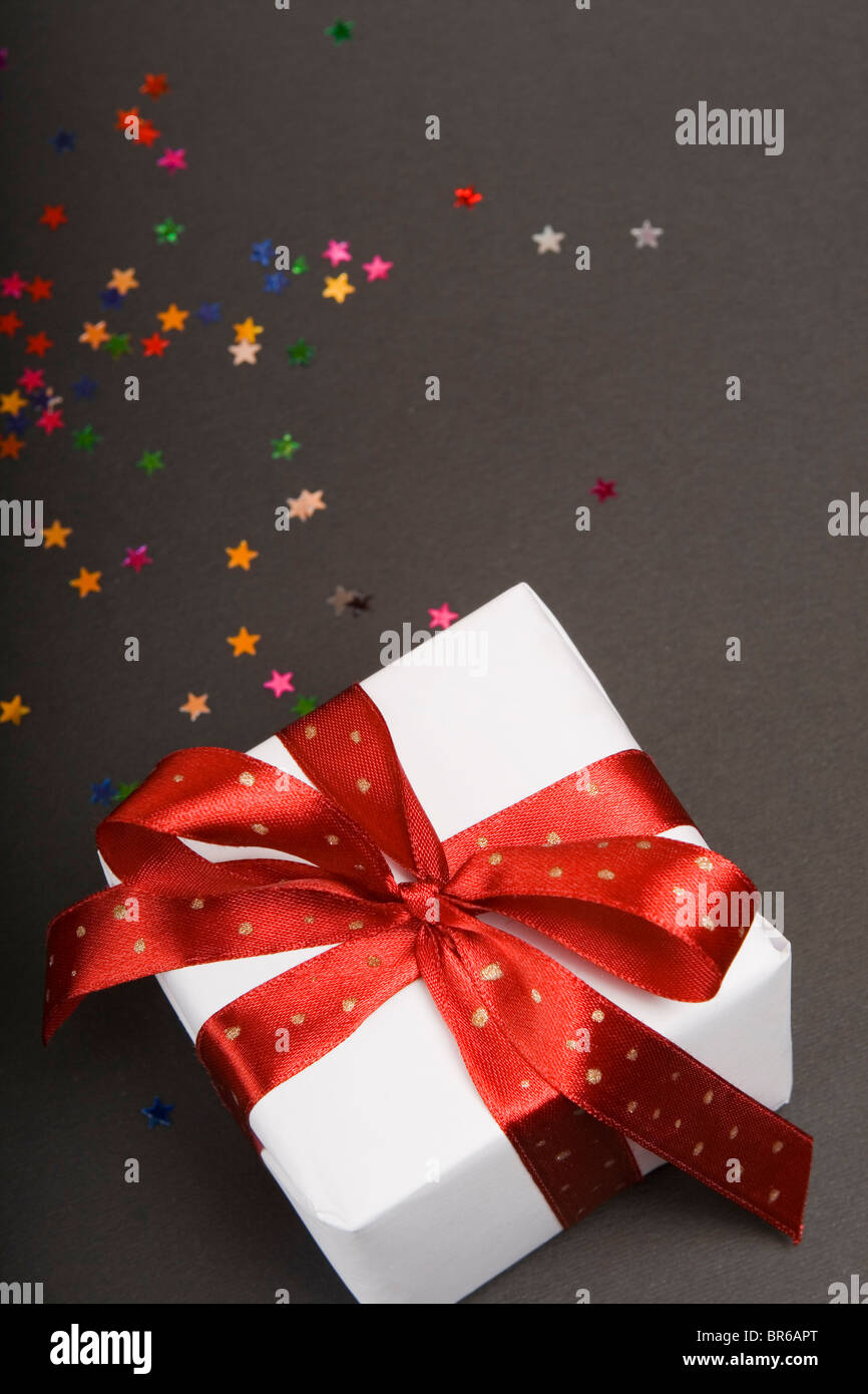 Gift with red ribbon Stock Photo - Alamy
