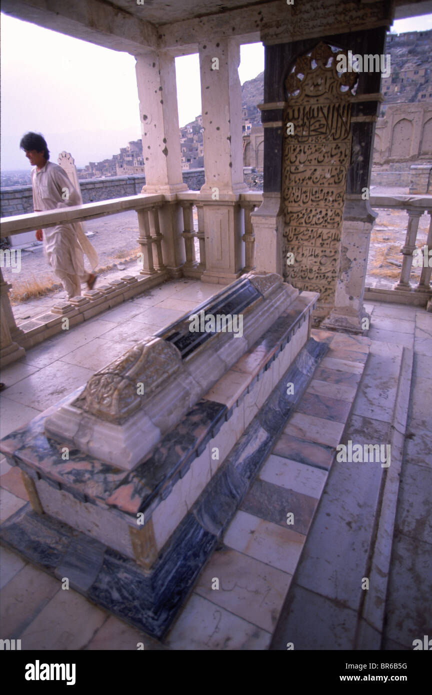 A man walks by the marble tomb of Babur in the Babur Gardens Kabul ...