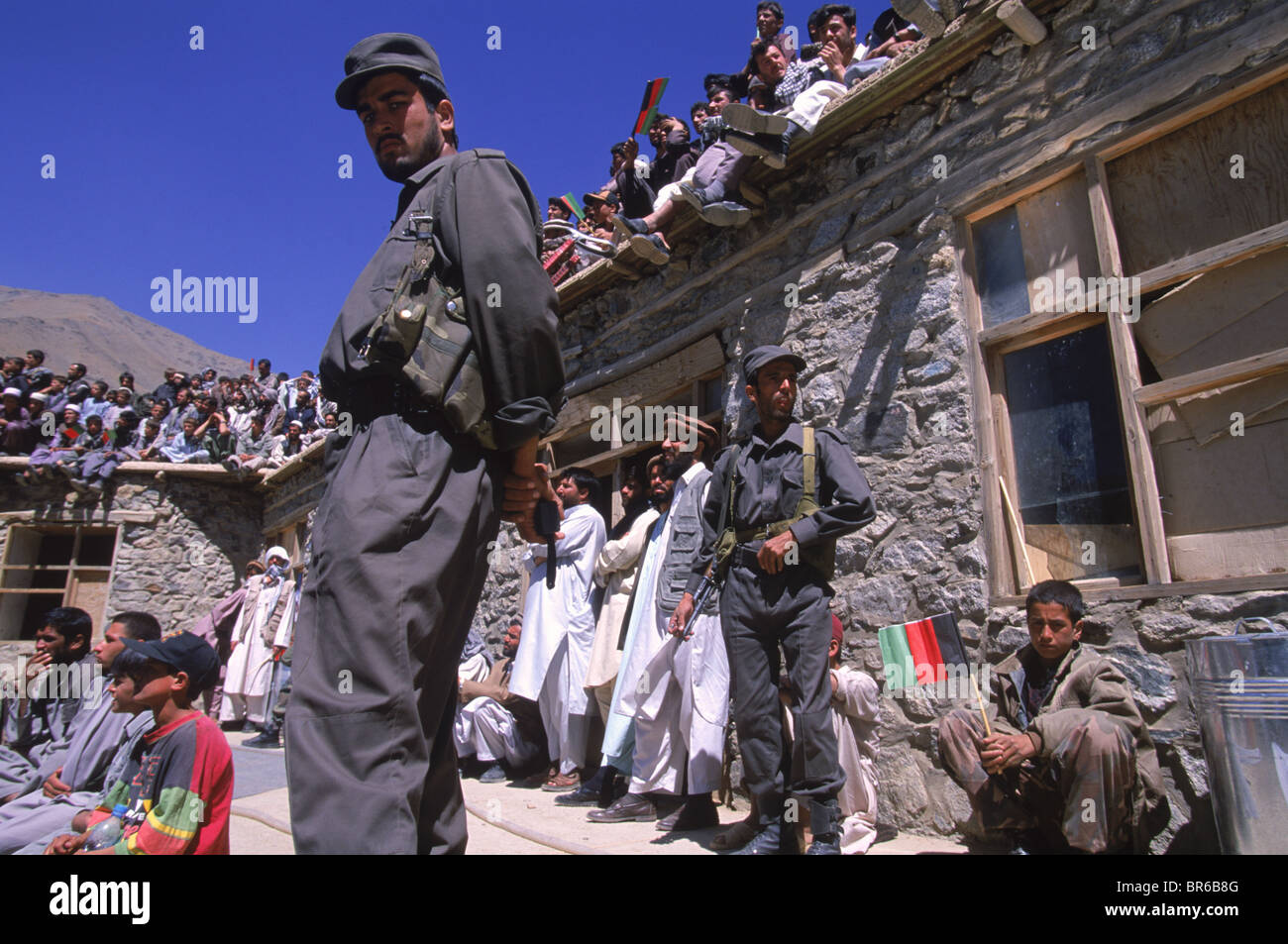 Armed guards keep an eye on crowds during a ceremony at the shrine of ...