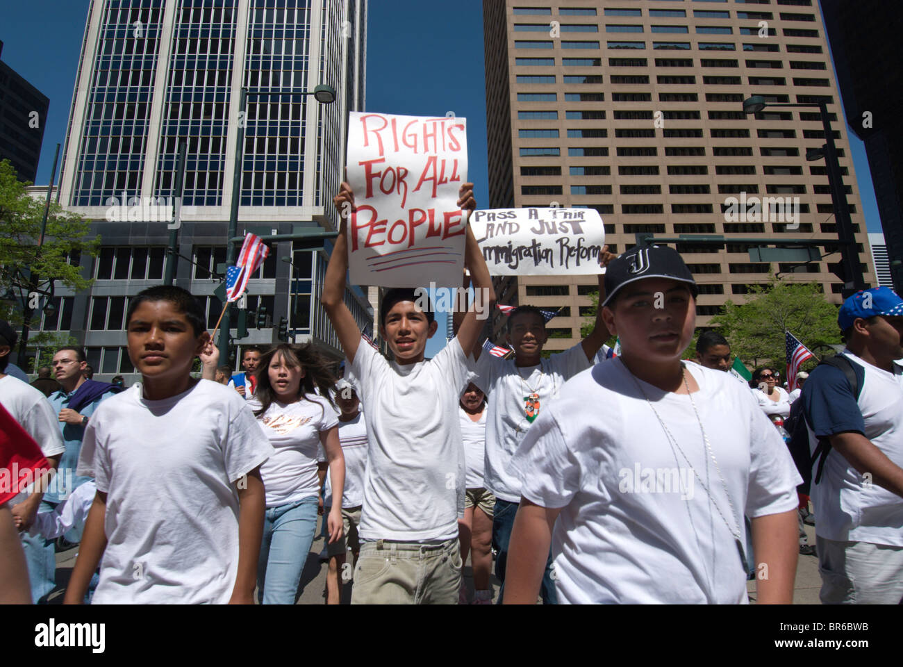 Young Latino demonstrators carry signs and chant as they march in a May ...