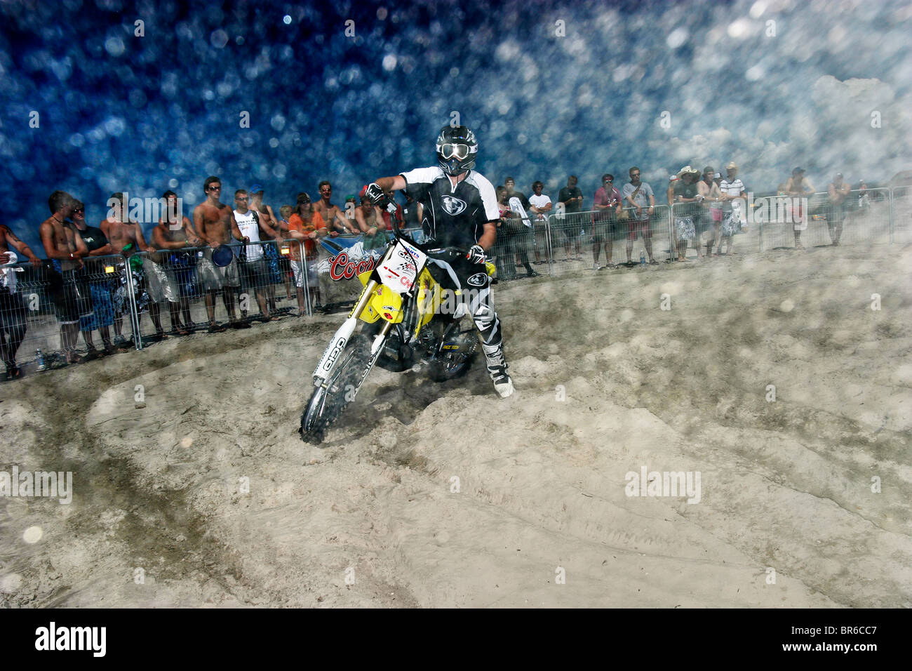 Motocross stunt rider kicks up dirt as he turns a corner Stock Photo ...