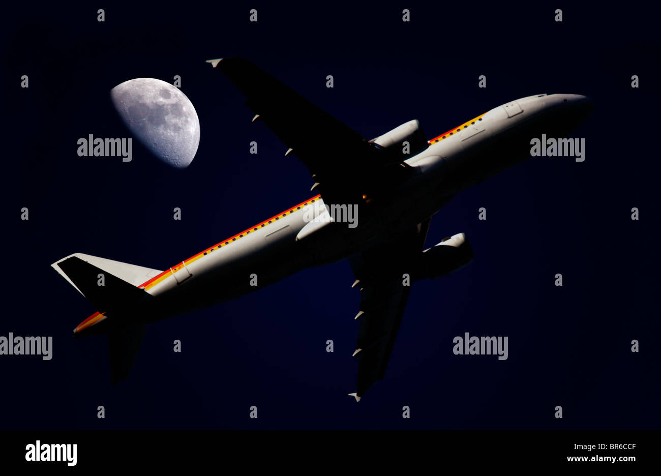 An airplane flying in the night under moonligth Stock Photo - Alamy