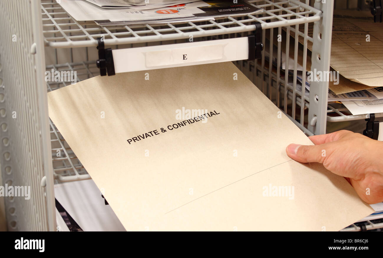 Receiving a private and confidential envelope in the office mailroom ...